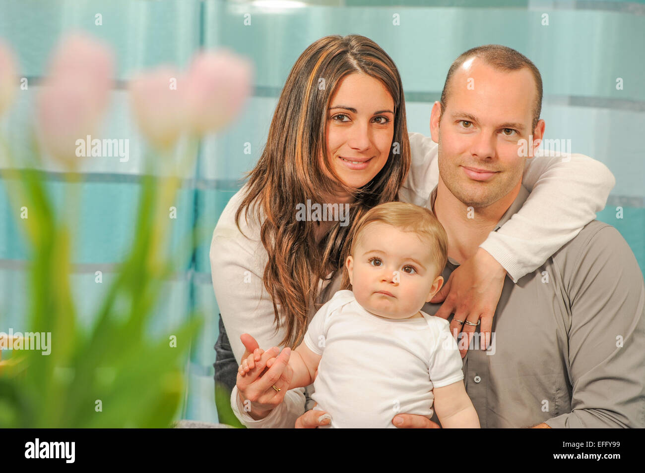 Parents Cuddling Newborn Baby Boy At Home Stock Photo - Alamy