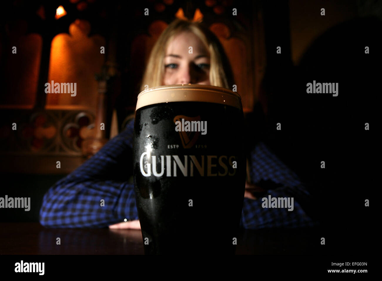 A woman with a pint of Guinness beer Stock Photo - Alamy