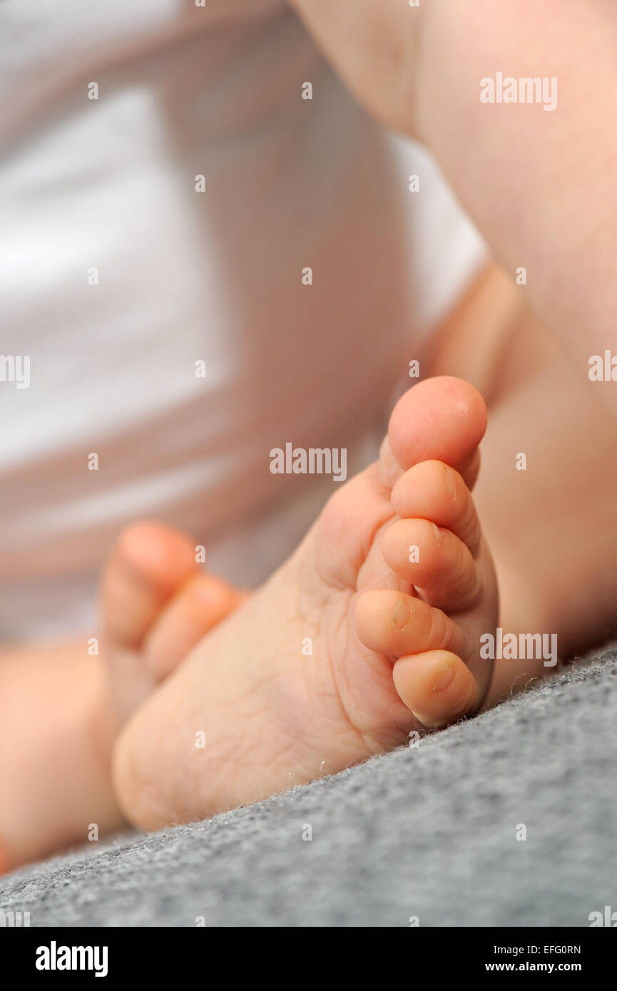 Baby touching feet hi-res stock photography and images - Alamy