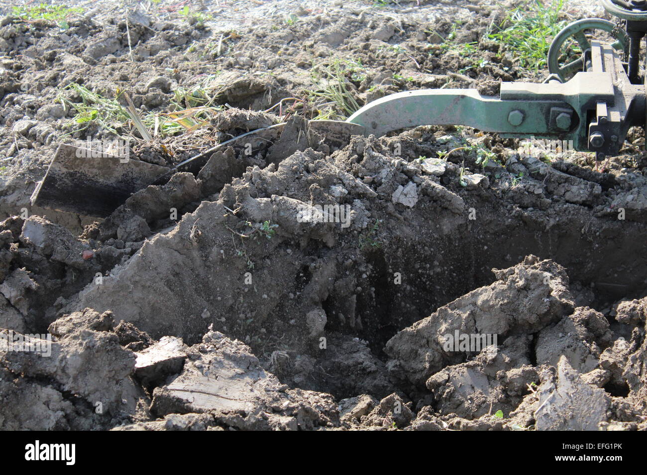 A farmer prepares the ground for planting by plowing the land Stock ...