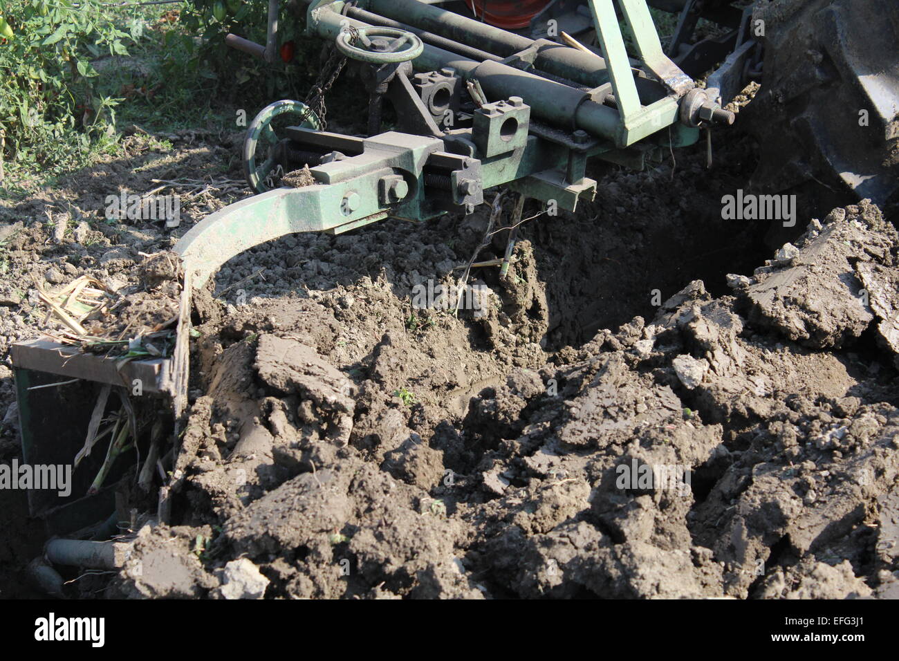 A farmer prepares the ground for planting by plowing the land Stock ...