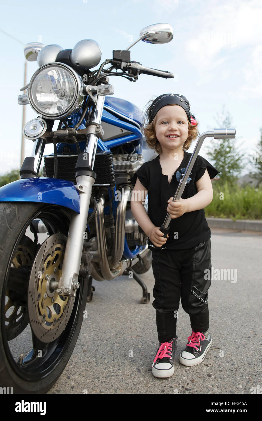 little biker repairs motorcycle on road Stock Photo - Alamy