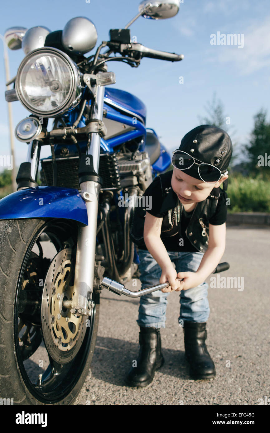little biker repairs motorcycle on road Stock Photo - Alamy