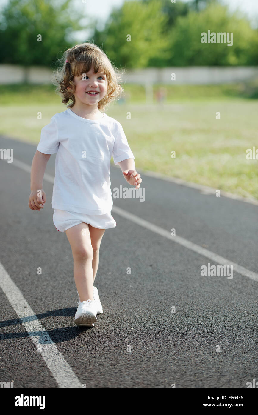 cute girl running at stadium photo Stock Photo - Alamy