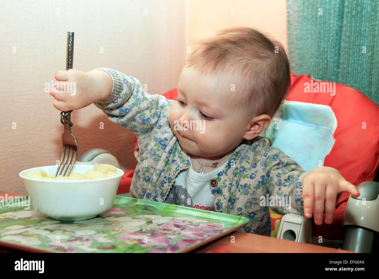 Little girl with fork in hand Stock Photo - Alamy