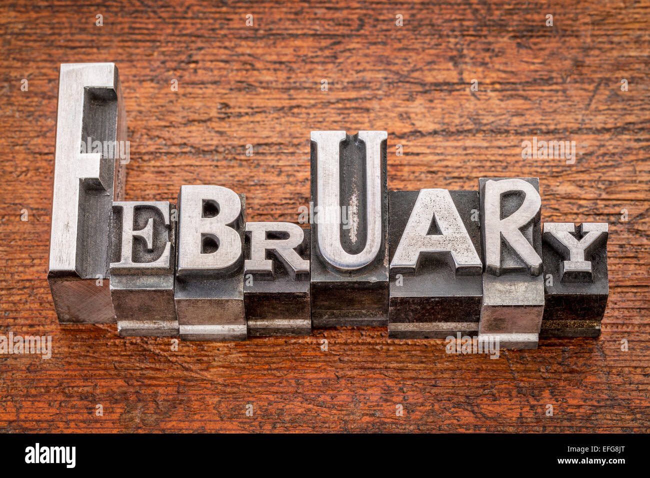 February word in mixed vintage metal type printing blocks over grunge ...