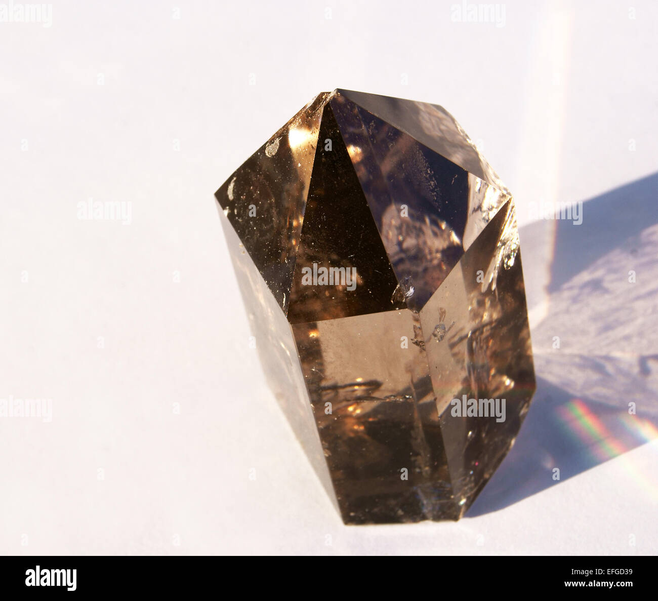 Smoky Quartz Crystal in natural sunlight with a rainbow reflection ...