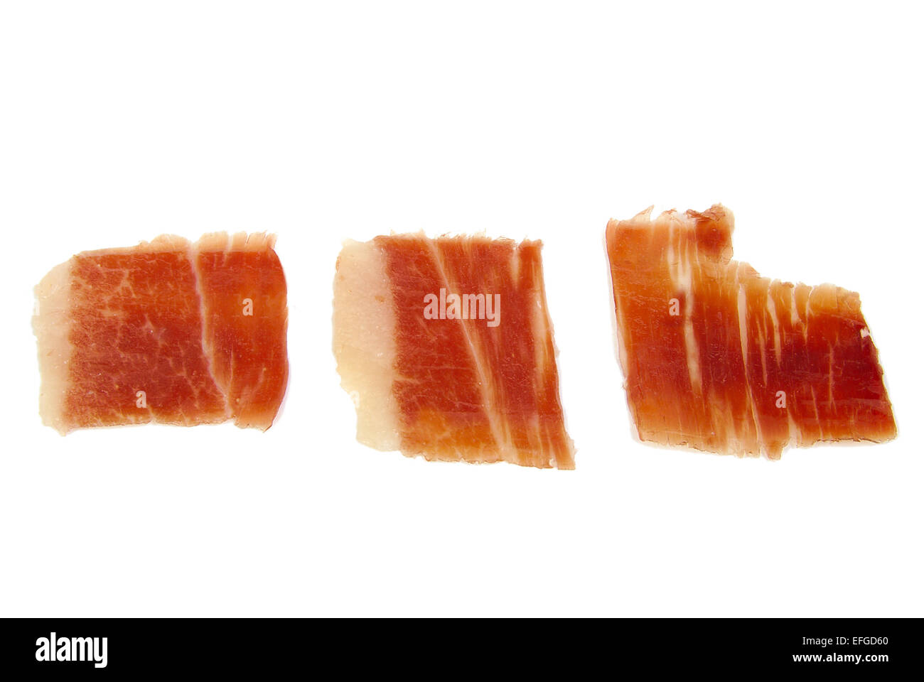 Closeup of three serrano ham slices isolated on white background ...