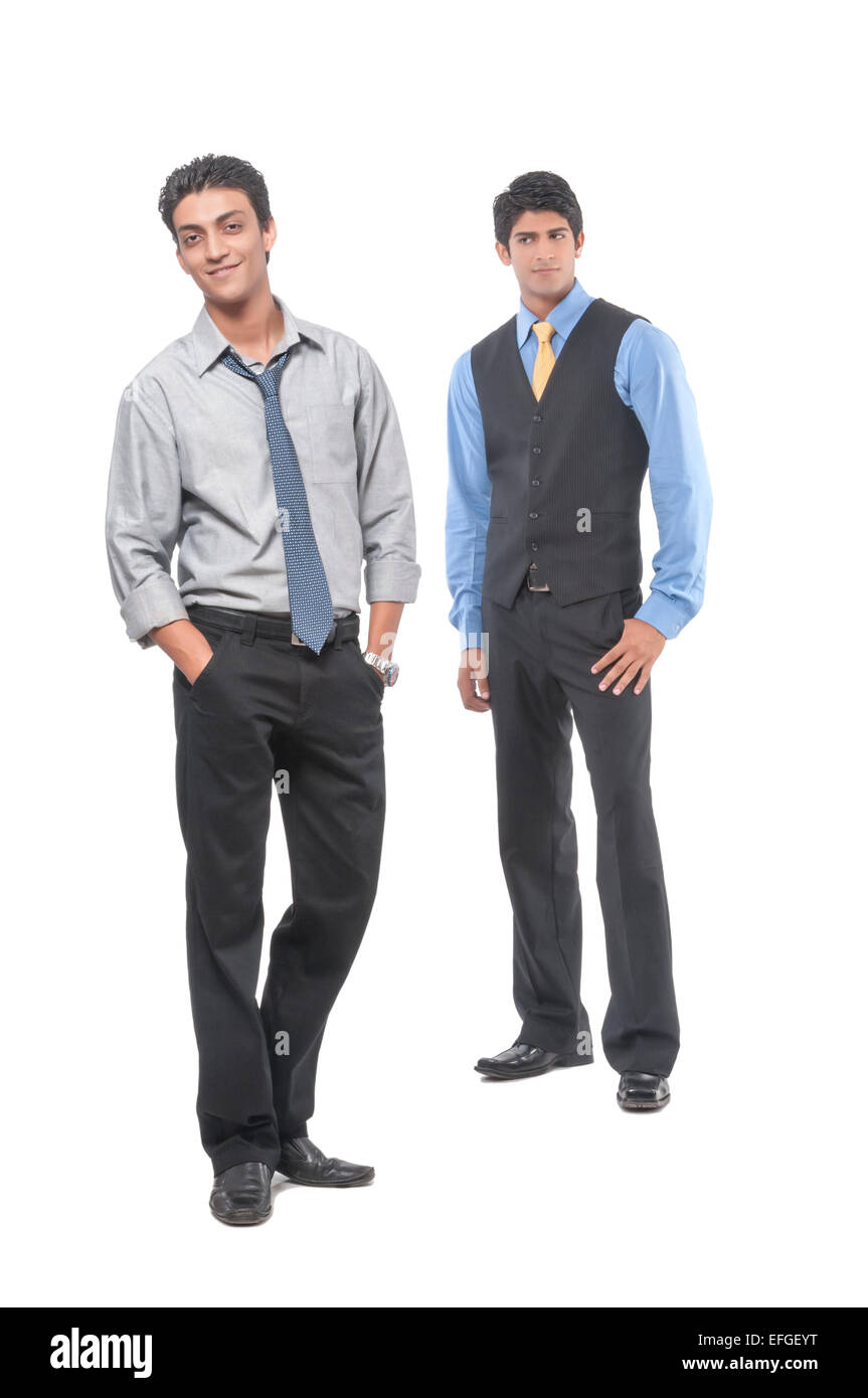 Two businessmen standing at a distance and one businessman smiling out ...