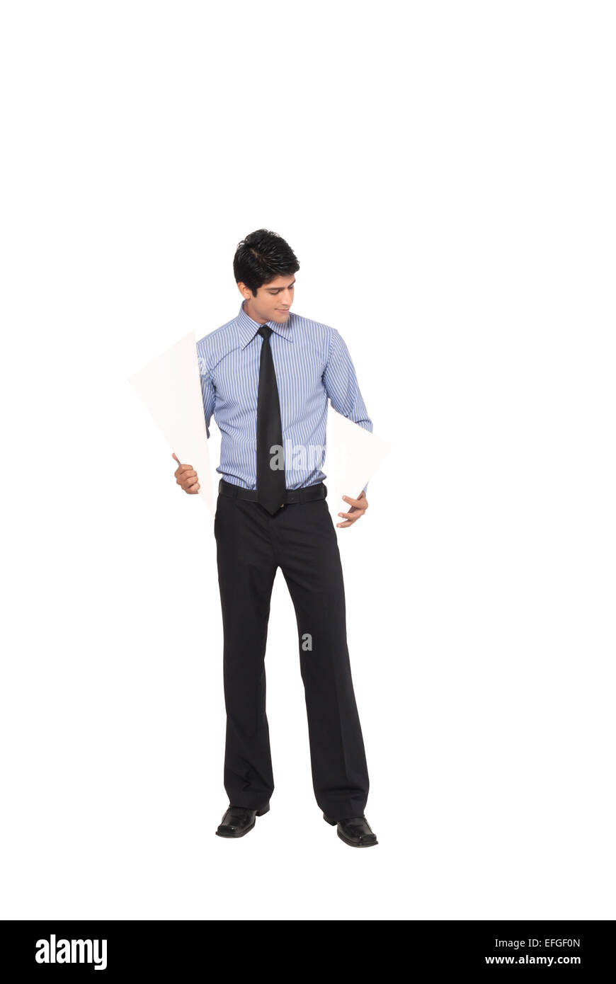 an Asian professional man standing, looking at the ground Stock Photo ...