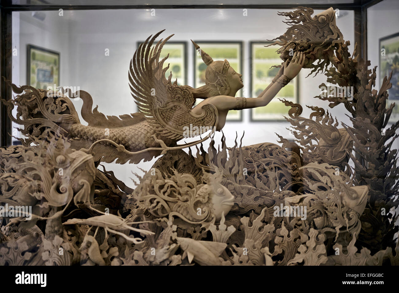 Ornately wooden carved winged mermaid figure submerged in a water tank ...