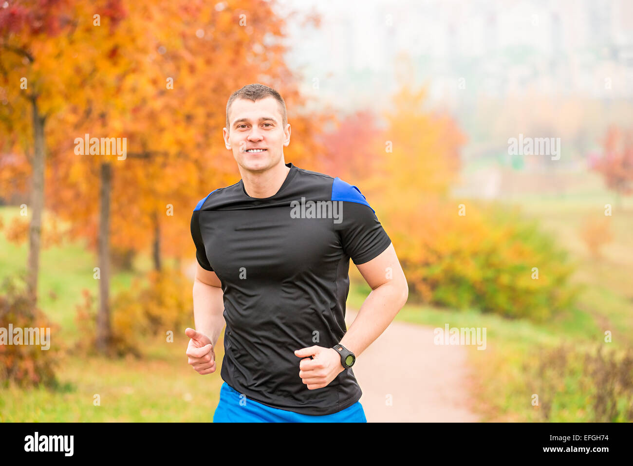 muscular man running on a footpath in the park Stock Photo - Alamy