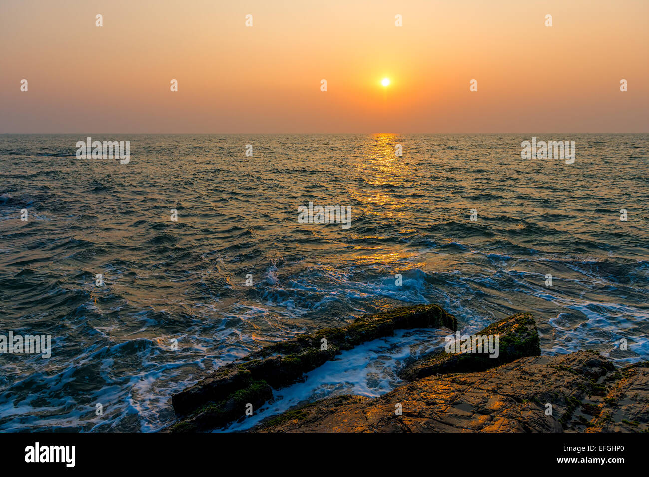 sea waves and orange sky at sunset Stock Photo - Alamy