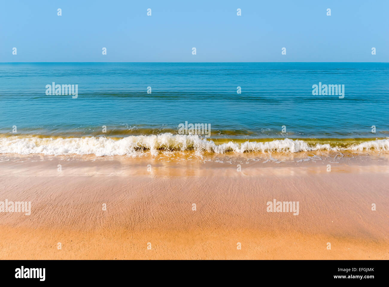 yellow sand and beautiful sea waves Stock Photo - Alamy