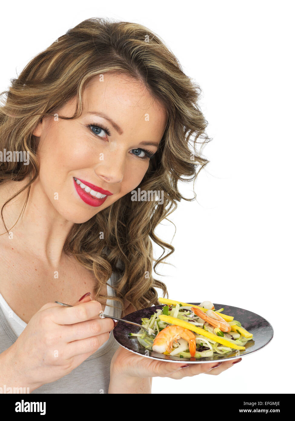 Healthy Young Woman Eating a Prawn and Mango Salad Stock Photo - Alamy