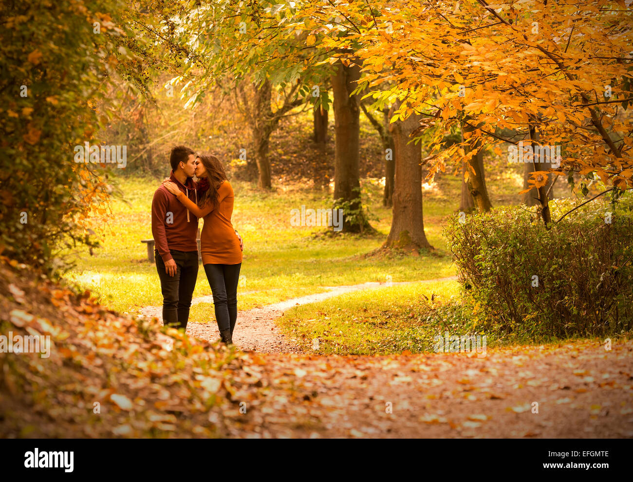 Kiss in autumn park Stock Photo - Alamy