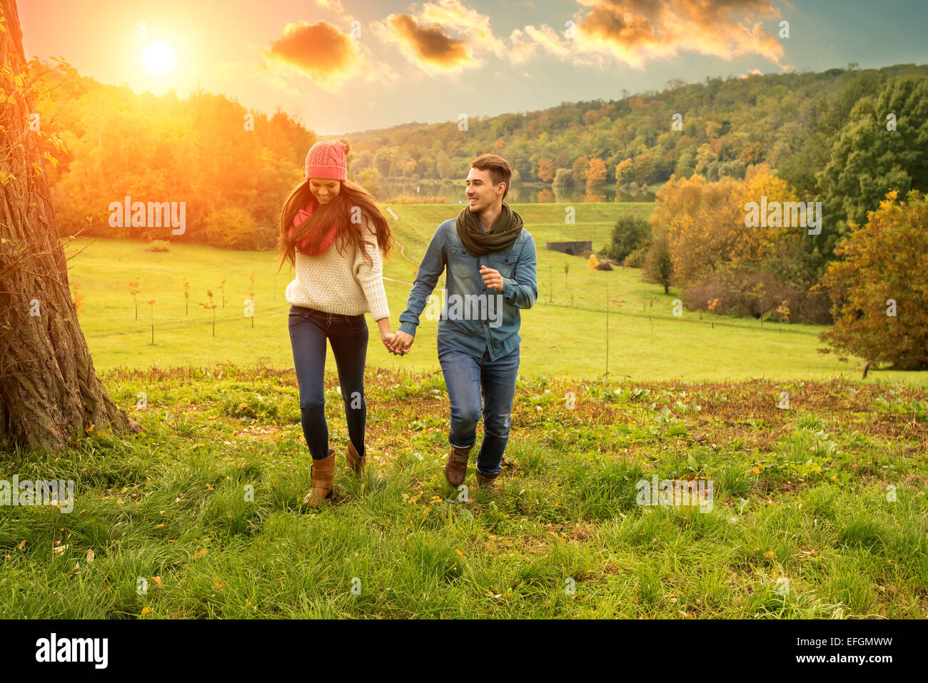 Young couple running on the beautiful scenery Stock Photo - Alamy