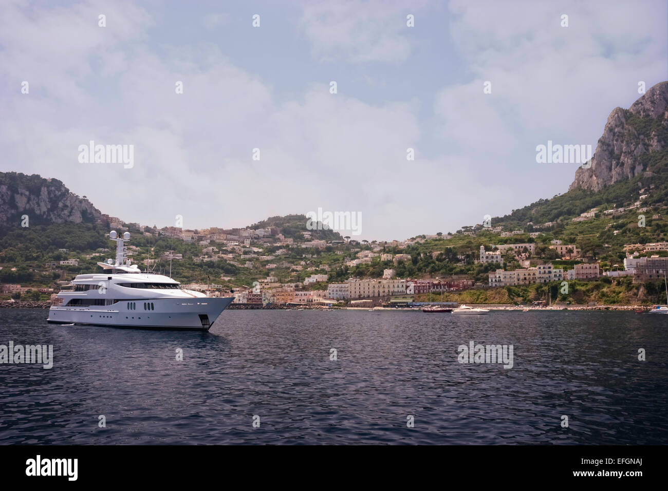 Yacht anchored at the coast of Capri, Italy. In the background Marina ...