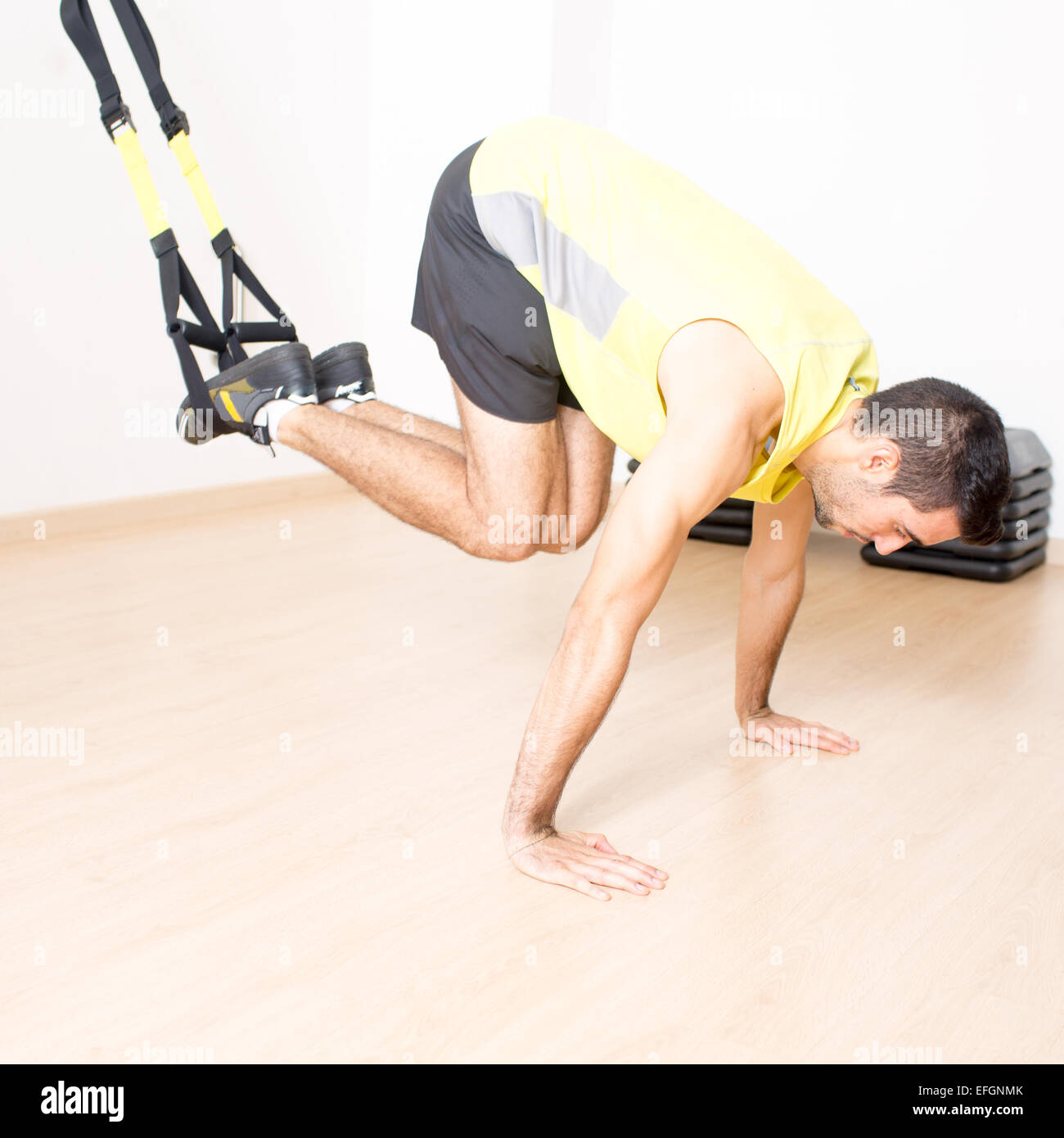 Athletic man makes TRX exercise Stock Photo - Alamy