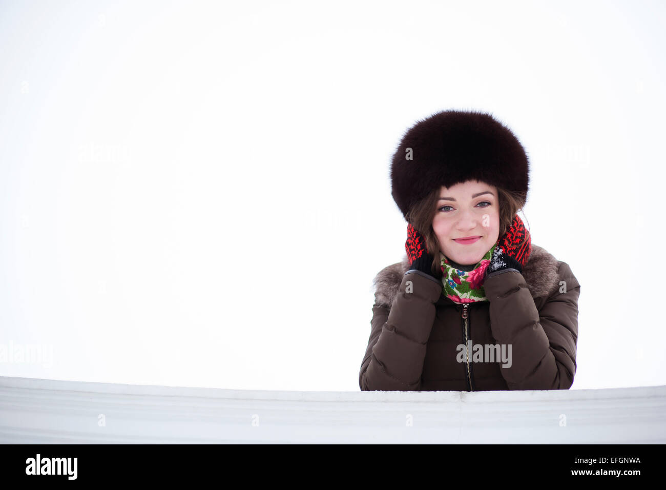 Flirting young brunette in love leaned on the fence Stock Photo - Alamy