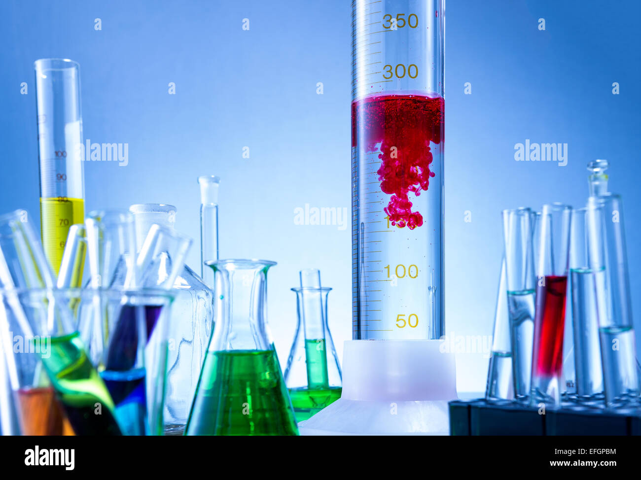 Laboratory equipment, bottles filled with colorful liquids, red liquid ...