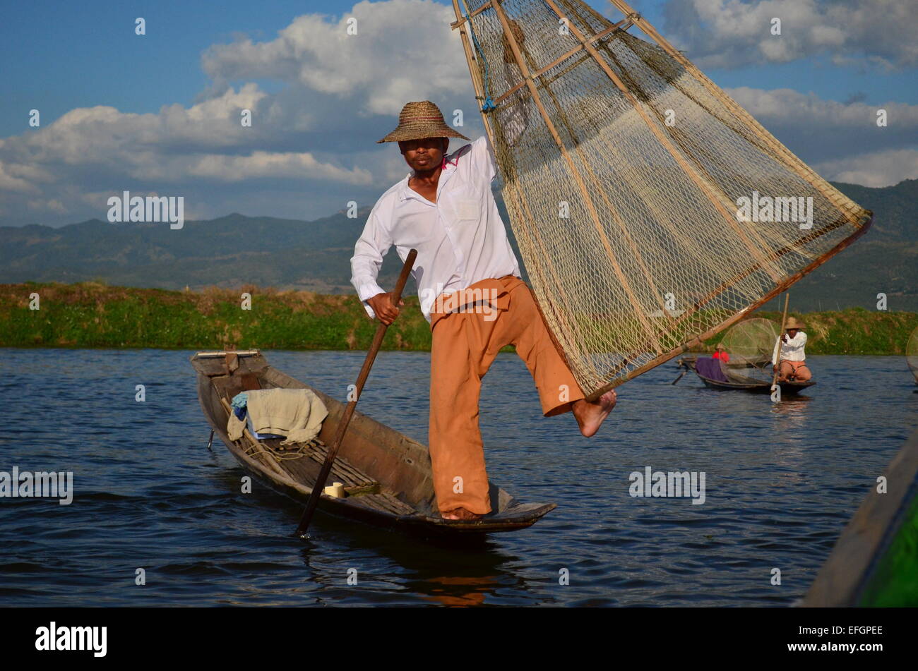 Fisherman standing in perfect balance on a boat Stock Photo - Alamy