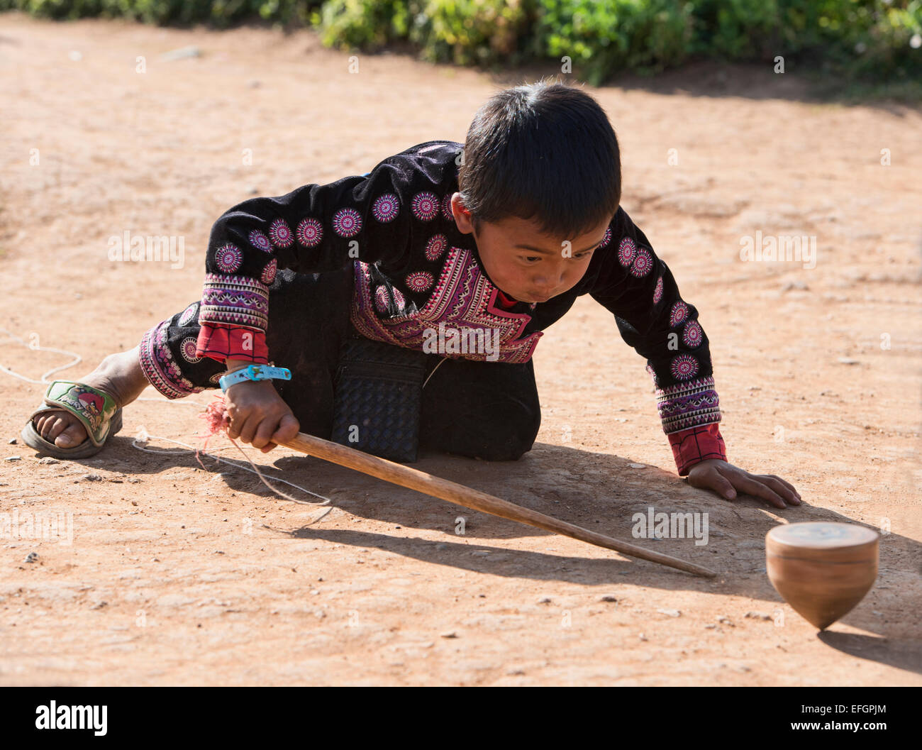 Hmong boy and his wooden top in Mon Jam, Chiang Mai, Thailand Stock ...