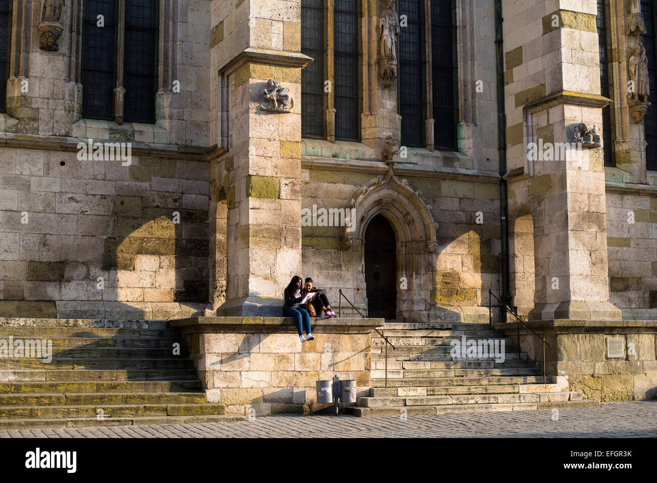Two student girls sitting on the stairs of St. Paul's Church in ...