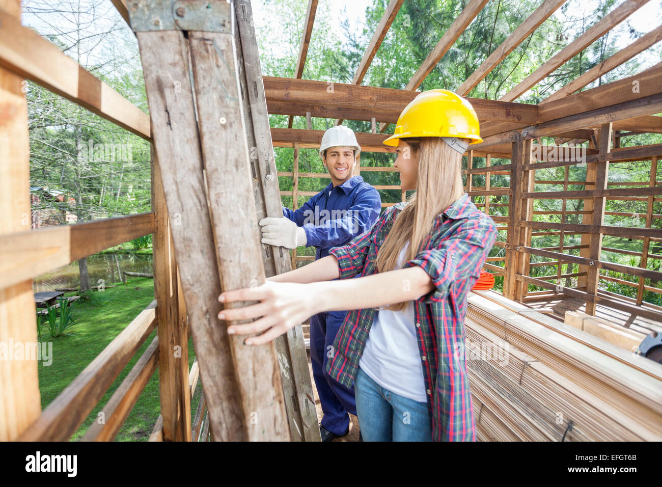 Smiling Construction Worker Working With Colleague At Site Stock Photo - Alamy