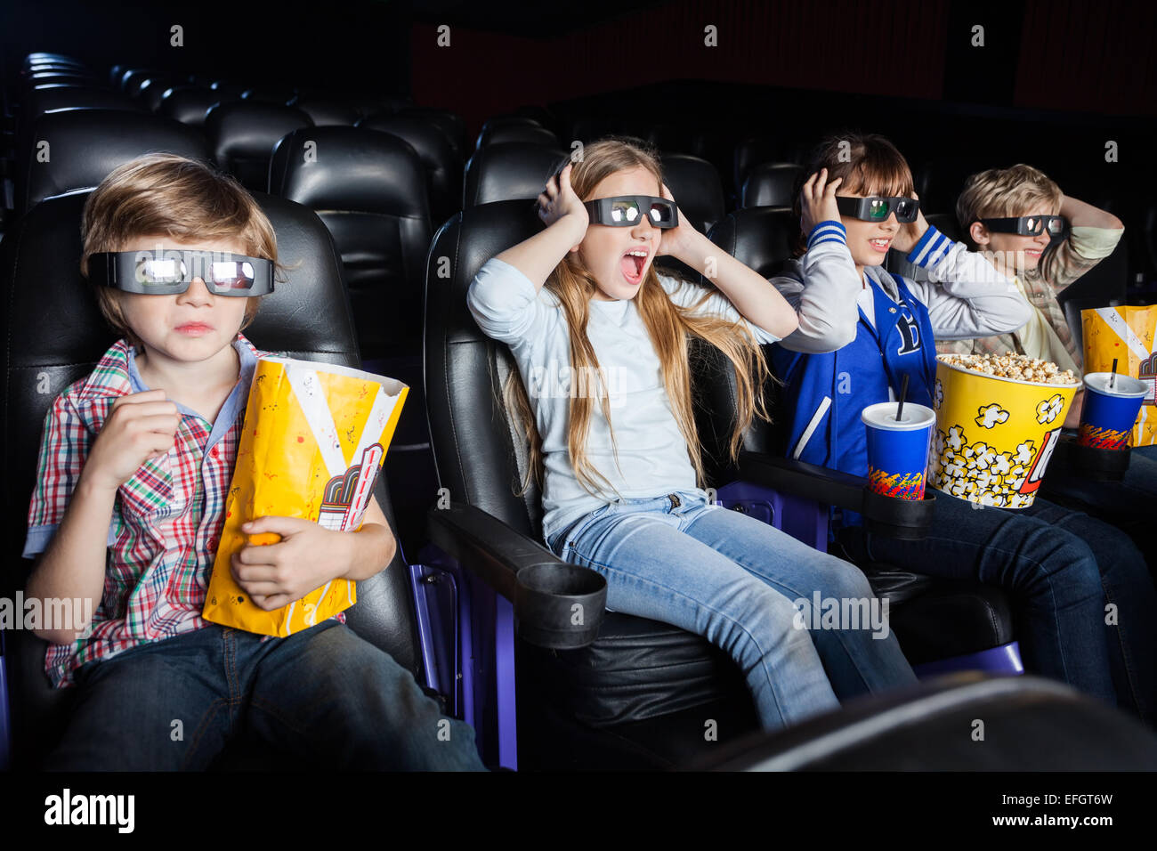 Scared Children Watching 3D Movie In Cinema Theater Stock Photo - Alamy