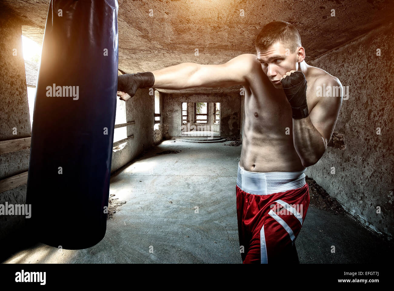 Young man boxing workout in an old building Stock Photo - Alamy