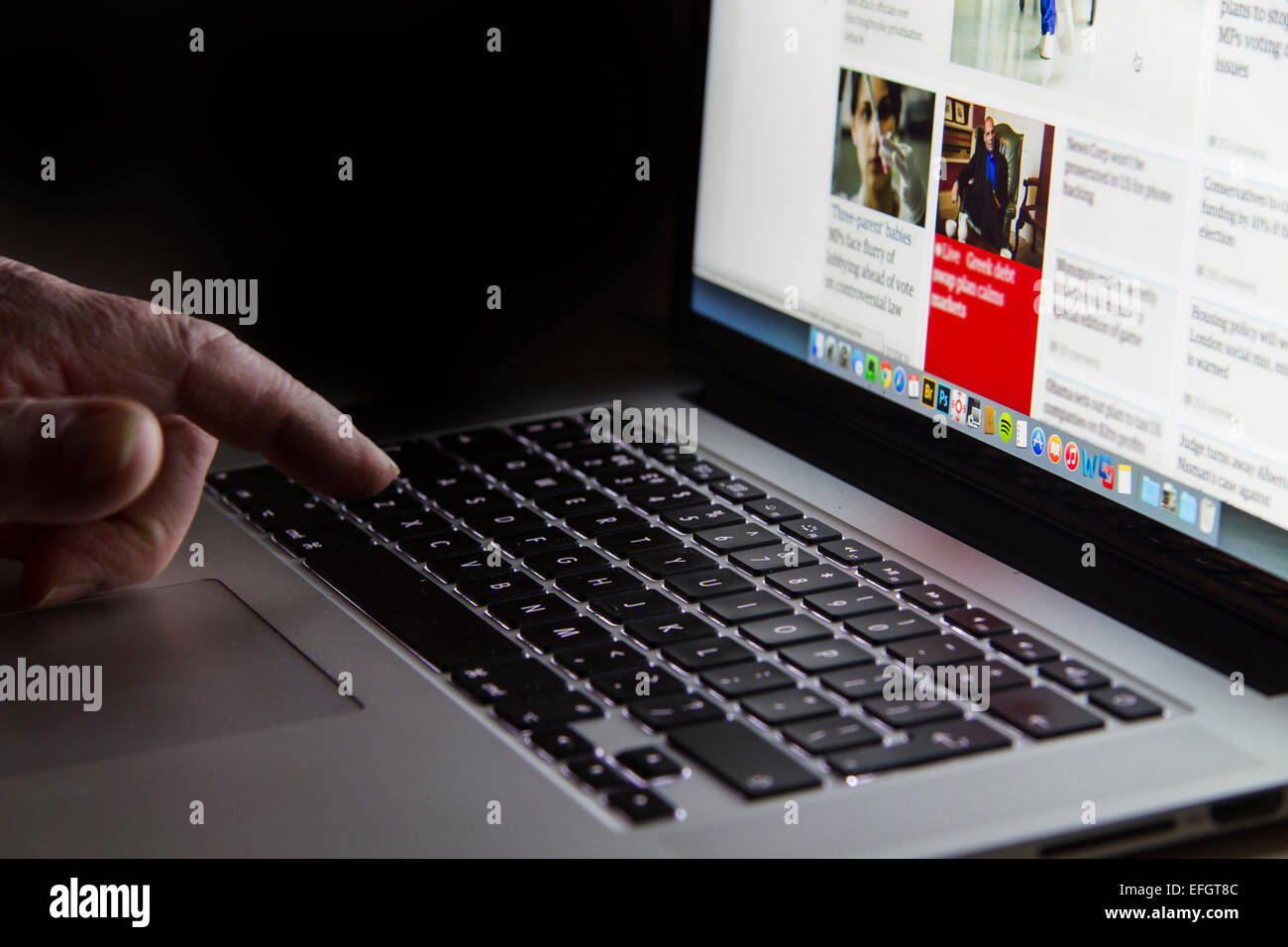Hand reaching out to the keyboard of a laptop computer Stock Photo - Alamy