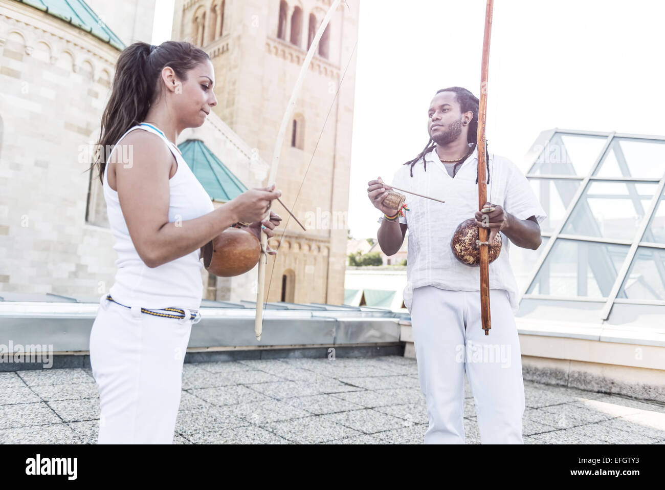 Young pair partners capoeira, berimbau musical instrument in their ...