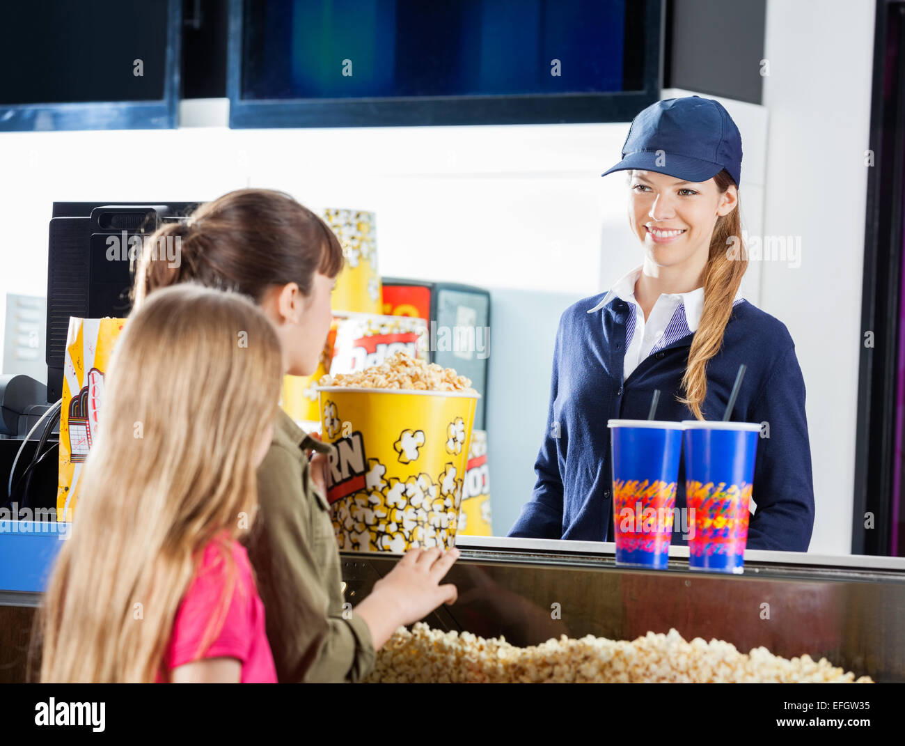 Girls Buying Snacks From Female Seller At Concession Stand Stock Photo ...