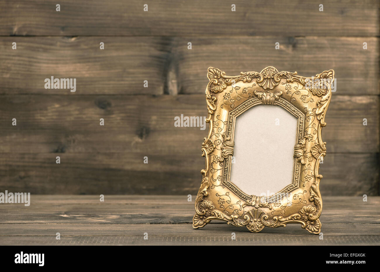 antique golden picture frame on rustic wooden background Stock Photo ...