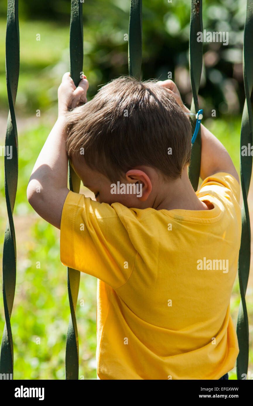 Child under barriers Stock Photo - Alamy