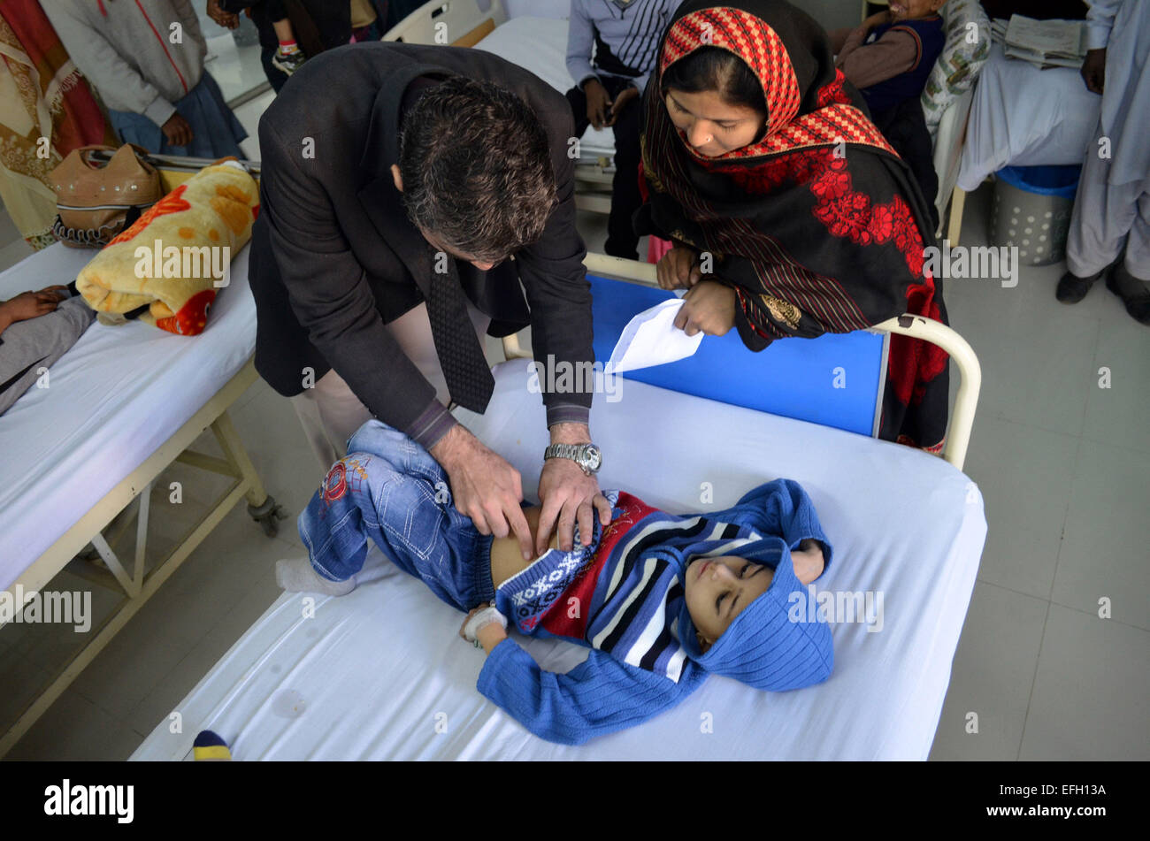 Lahore. 4th Feb, 2015. A doctor checks a patient at a diagnostic center ...