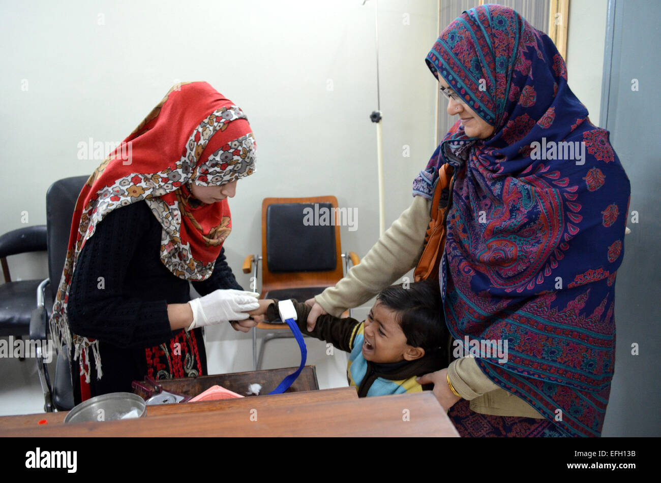 Lahore. 4th Feb, 2015. A doctor checks a patient at a diagnostic center ...