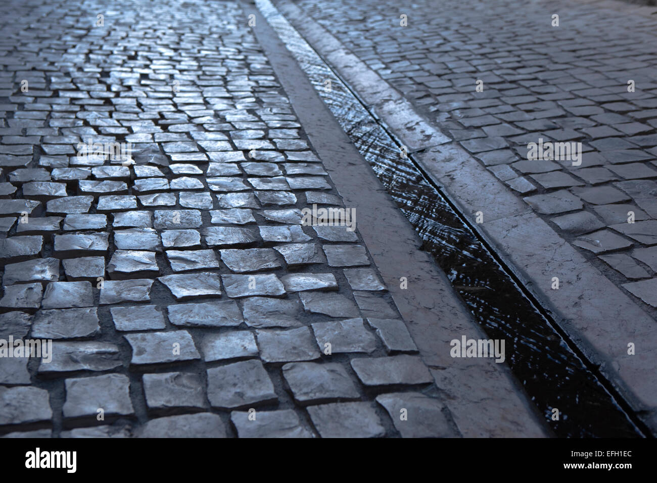 Paved street and gutter in the city Stock Photo - Alamy