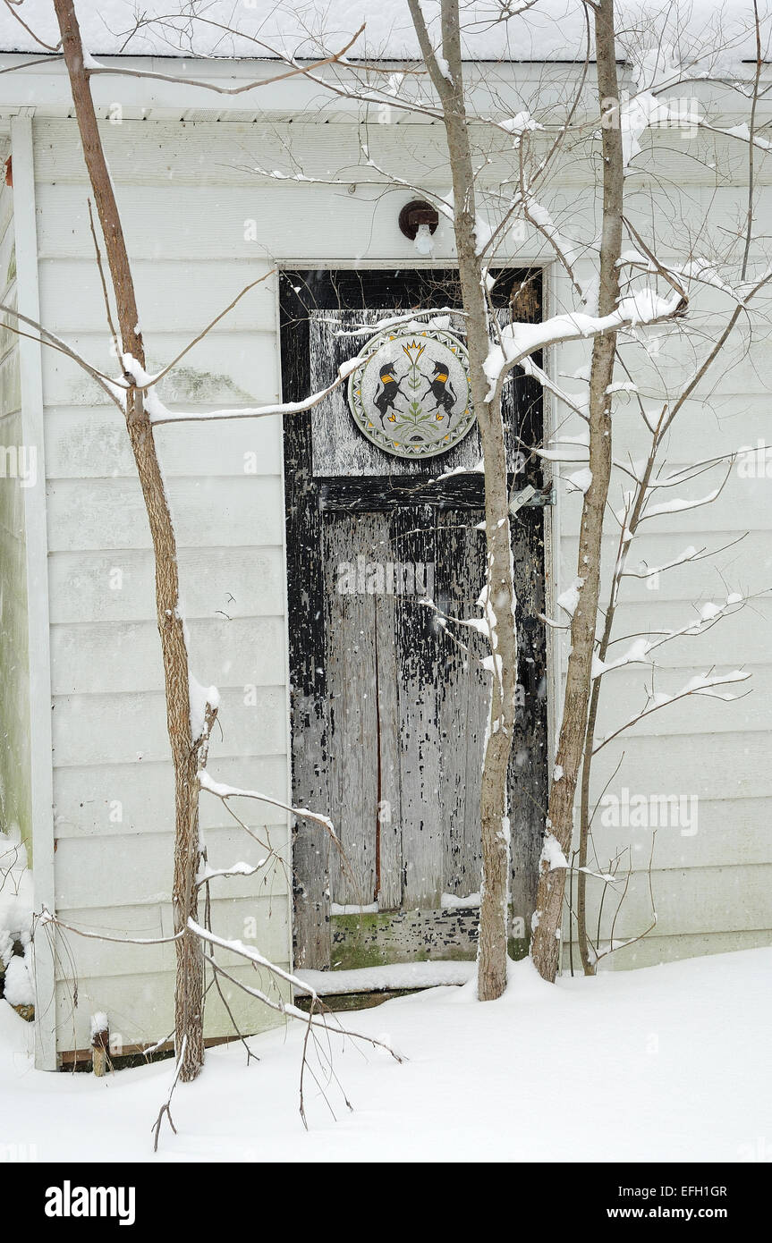 Garage door with Horse Crest blocked by trees growing Stock Photo - Alamy