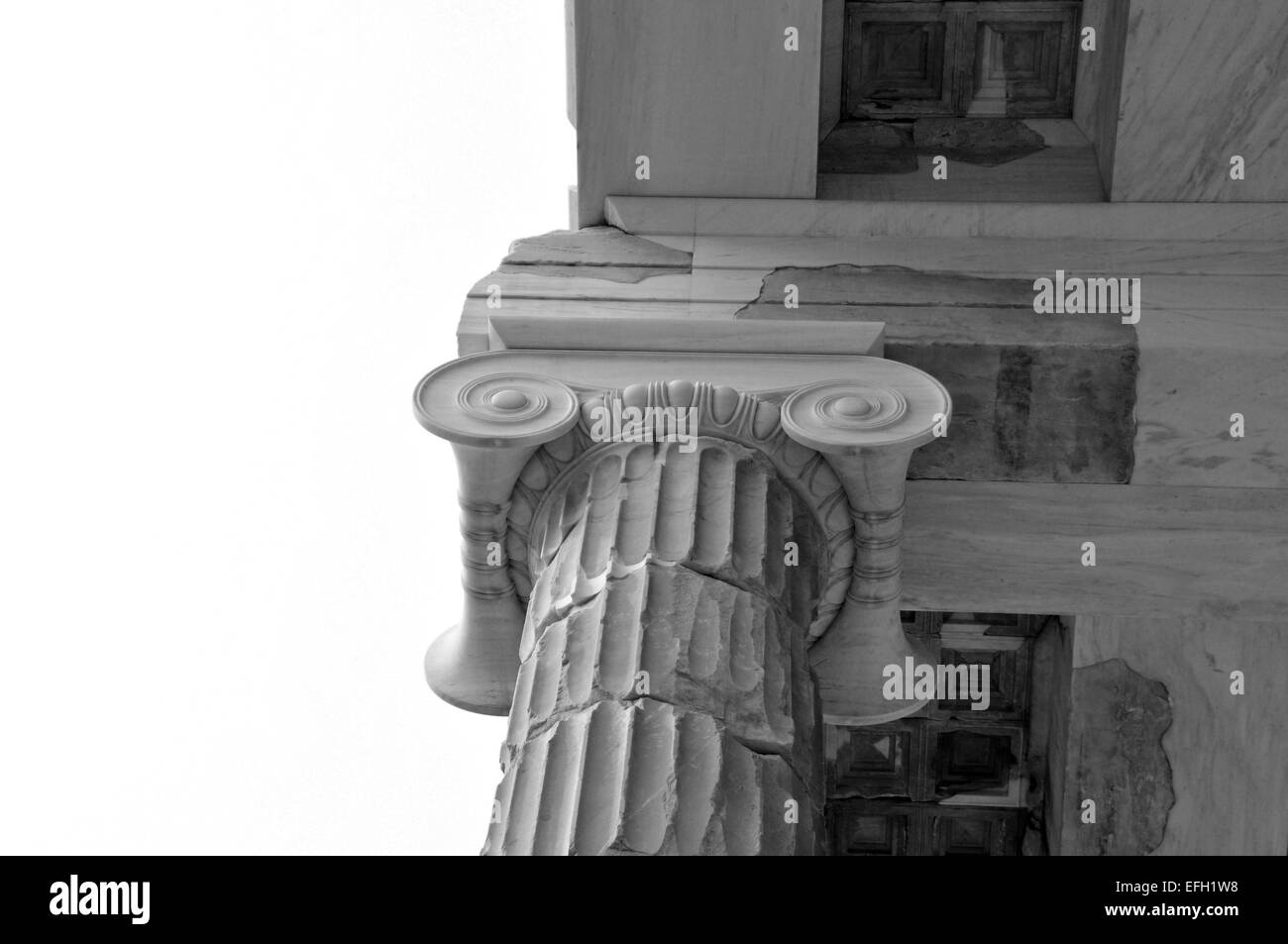 Detail of marble ionic column on white background. Propylaea gate to ...