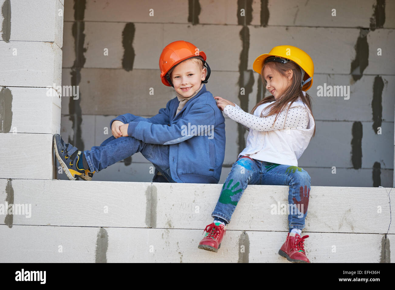 boy and girl playing on construction site Stock Photo - Alamy
