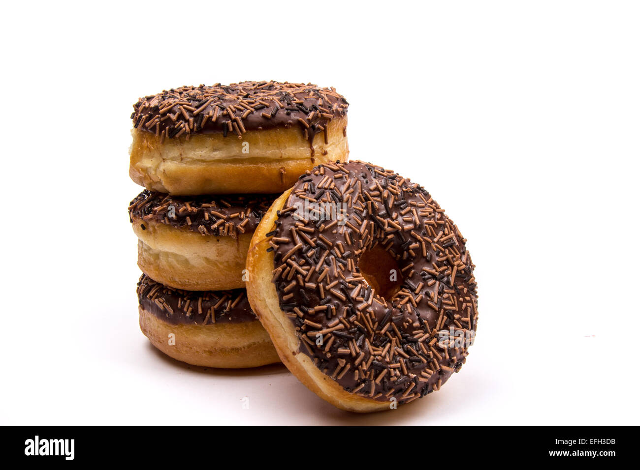 A pile of chocolate iced ring donuts on a white background Stock Photo ...