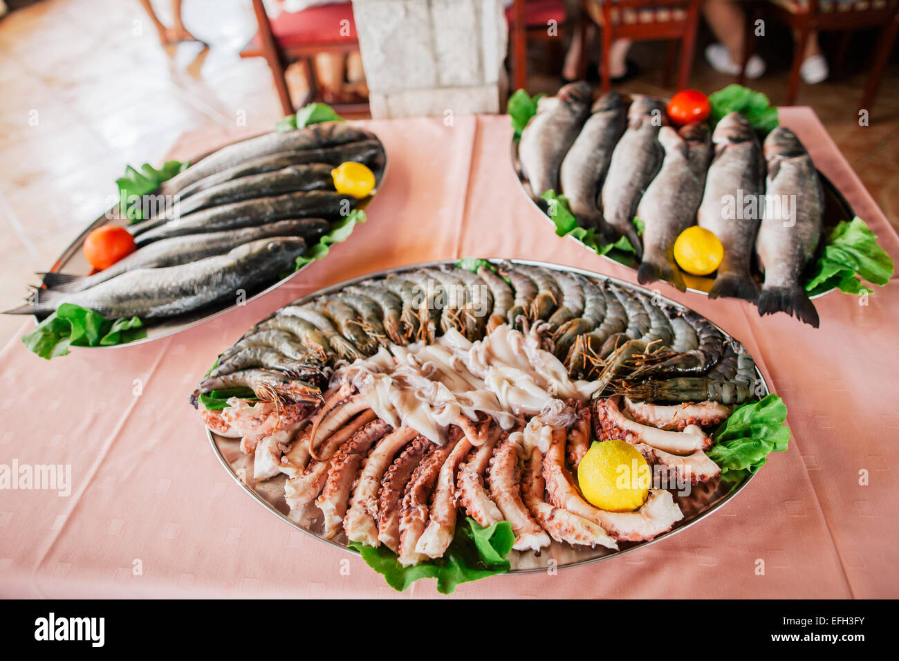 fresh raw seafood. Fish, octopus, seabass ready for cooking Stock Photo ...