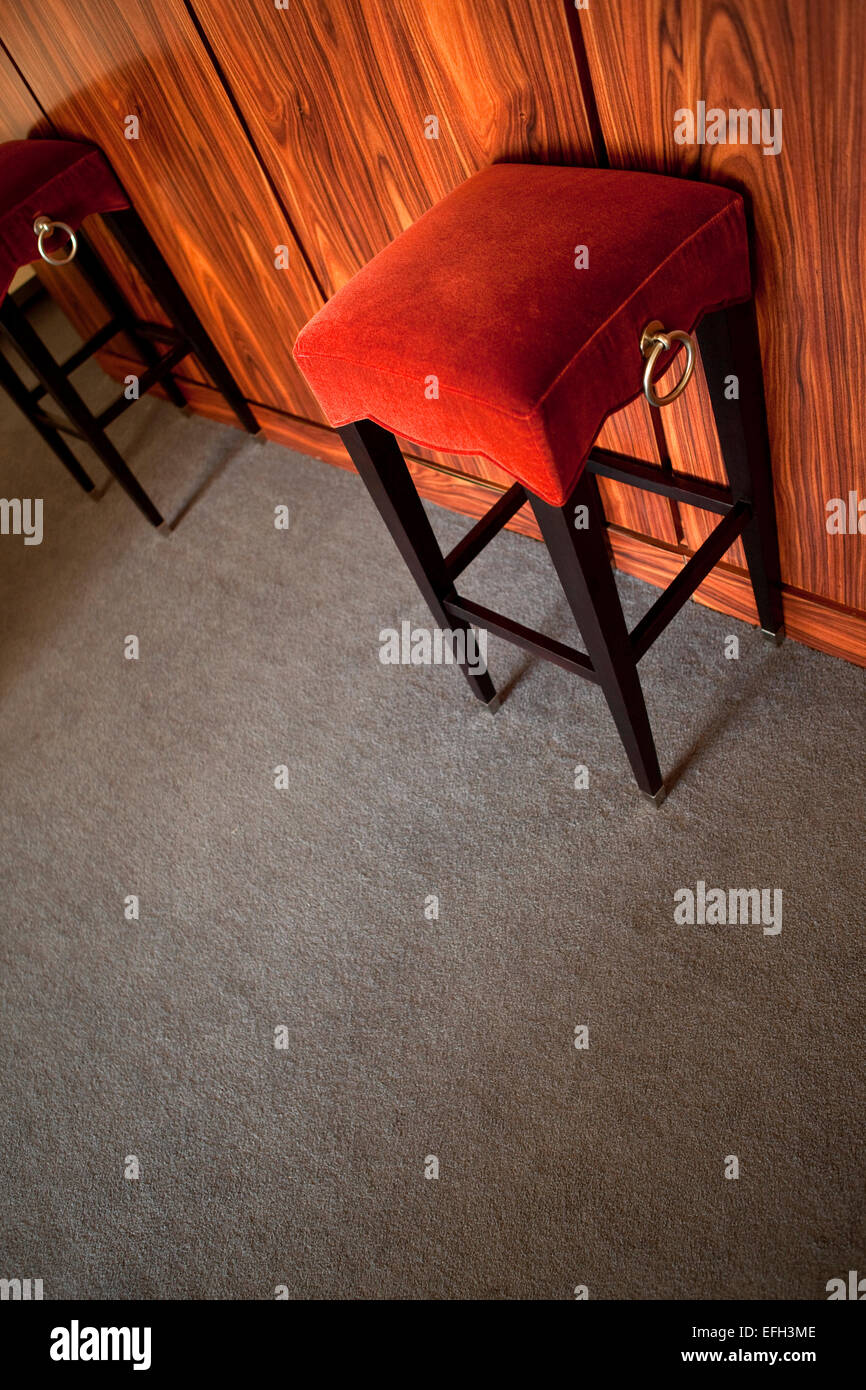 Red velvet stool in a luxurious pub Stock Photo - Alamy