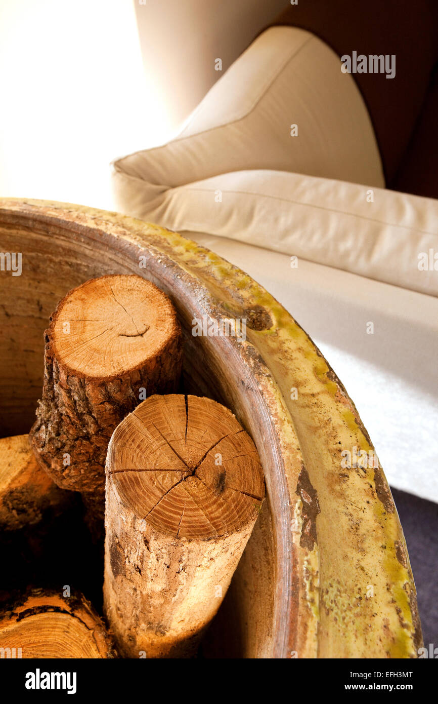 Logs in a clay pot Stock Photo - Alamy