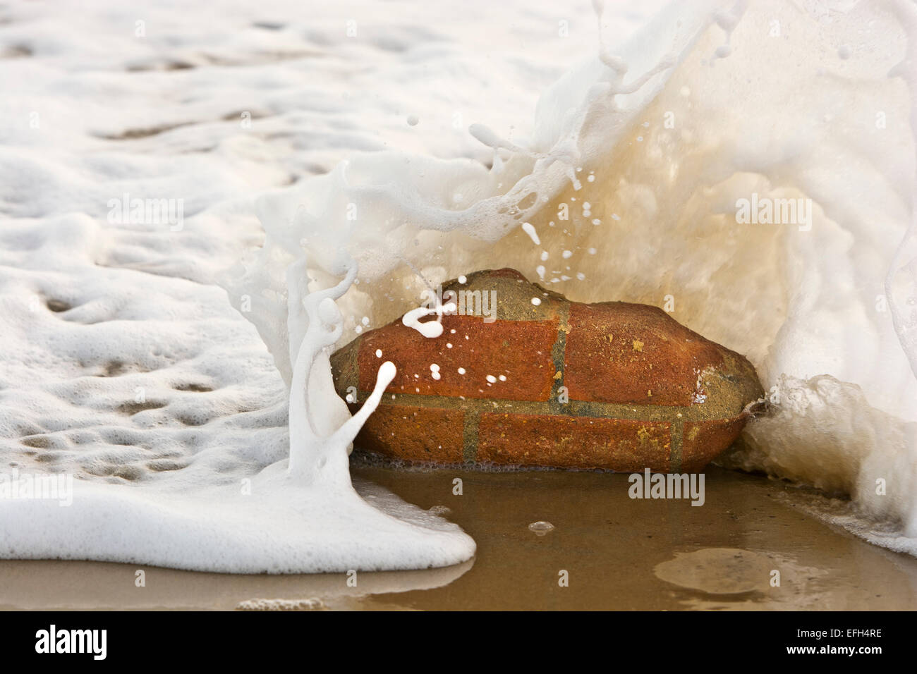 bricks in sea water coastal erosion raising sea levels Stock Photo - Alamy