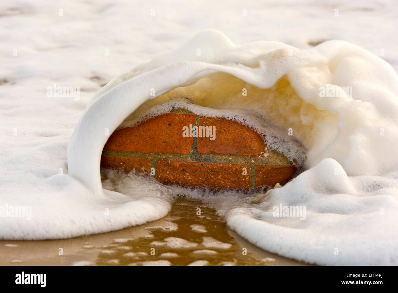 bricks in sea water coastal erosion raising sea levels Stock Photo - Alamy
