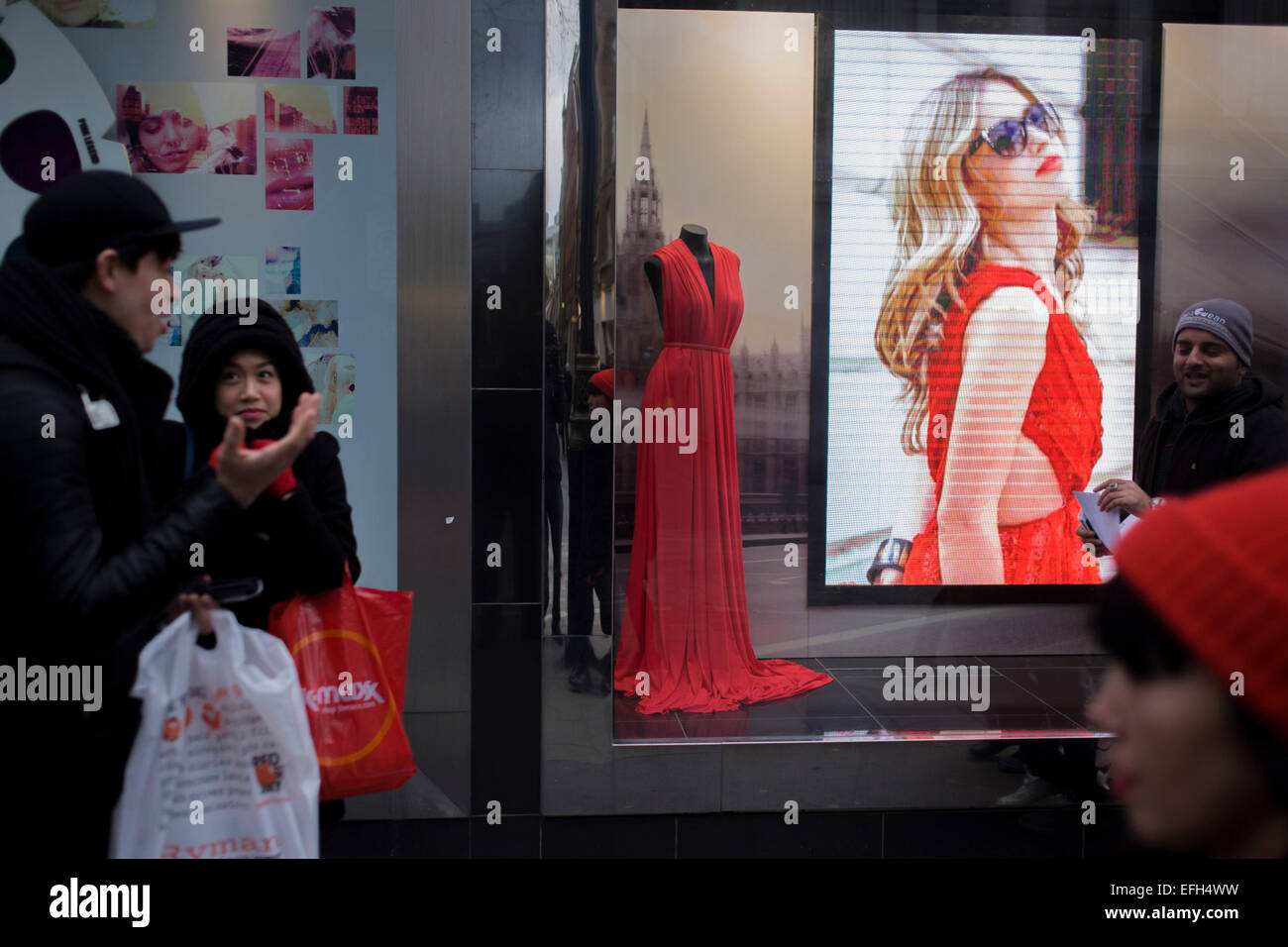 Blonde model shown on a video loop in a central London shop window, in ...