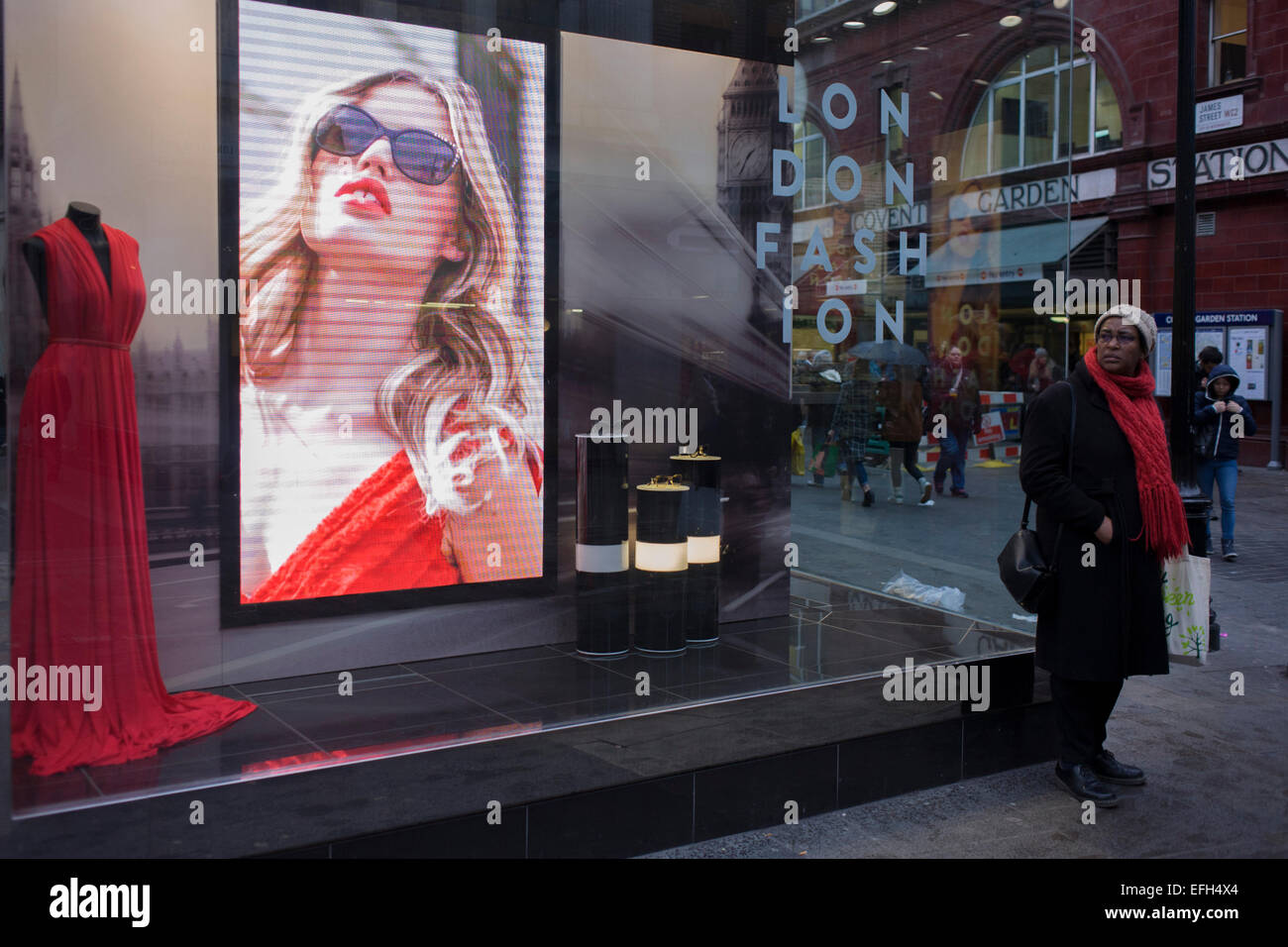 Blonde model shown on a video loop in a central London shop window, in ...